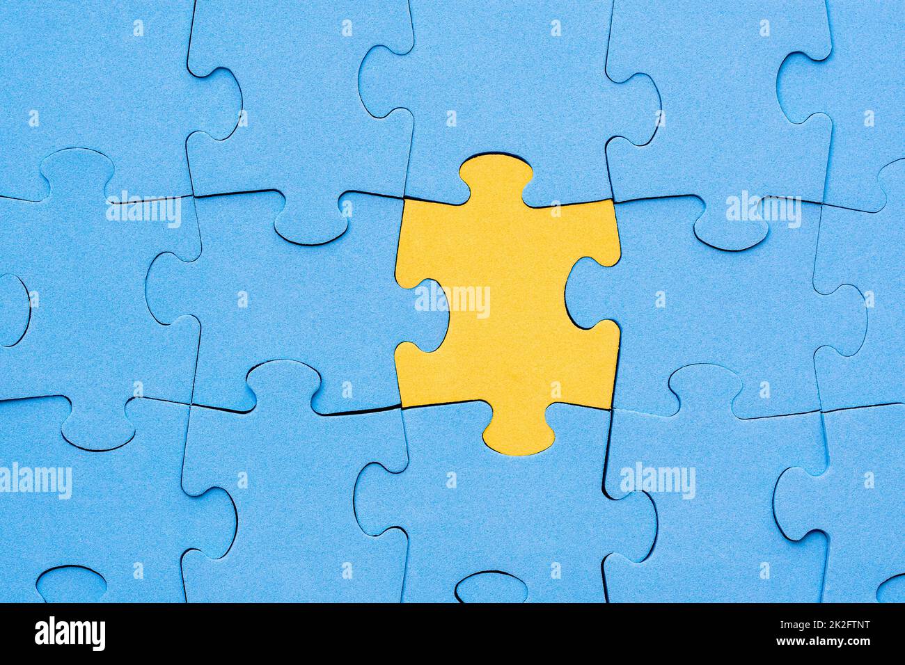 Yellow jigsaw puzzle piece stands out from the crowd Stock Photo - Alamy