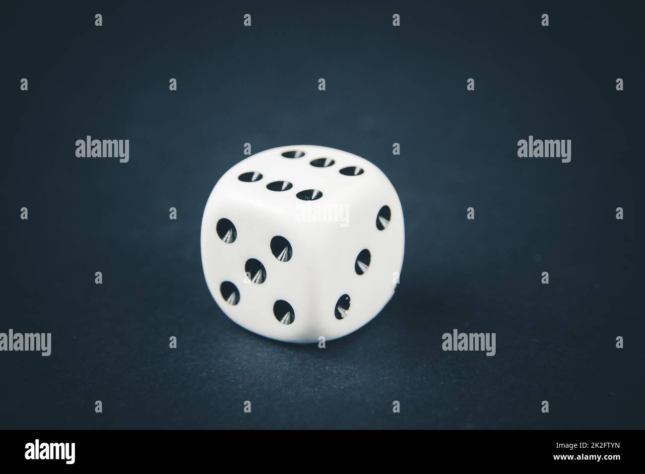 White dice on black table background Stock Photo - Alamy