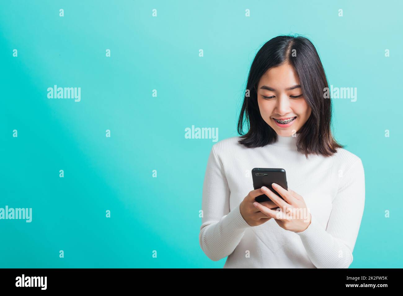 woman smile she holding and typing text message Stock Photo - Alamy