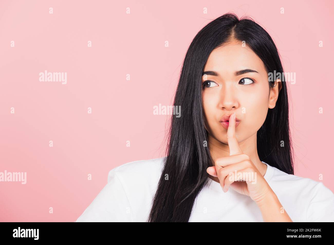 woman smile stand making finger on lips mouth silent quiet gesture ...