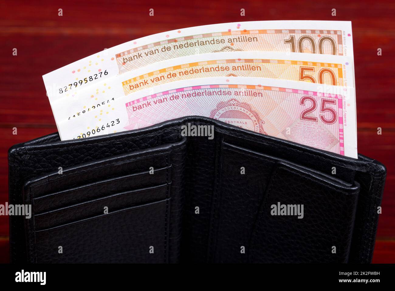 Netherlands Antillean guilder in the black wallet Stock Photo - Alamy