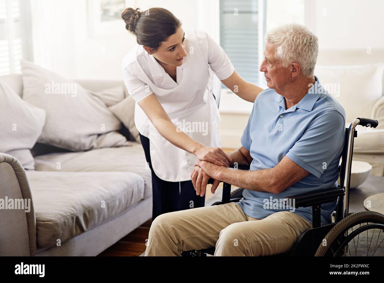 Helping Him Throughout His Day Shot Of A Caregiver Helping A Senior