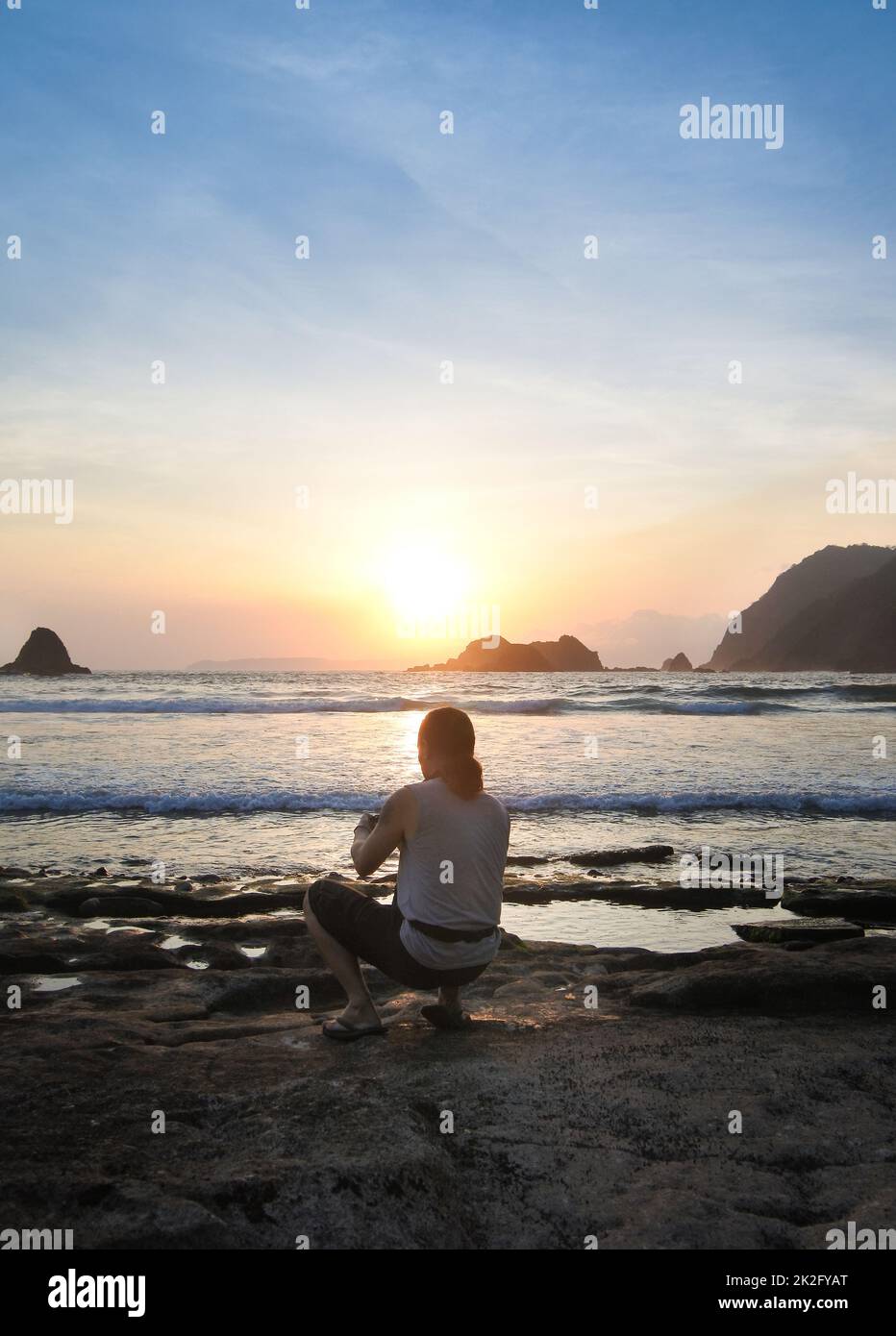A Man taking photos around Papuma beach in Jember, East Java, Indonesia ...