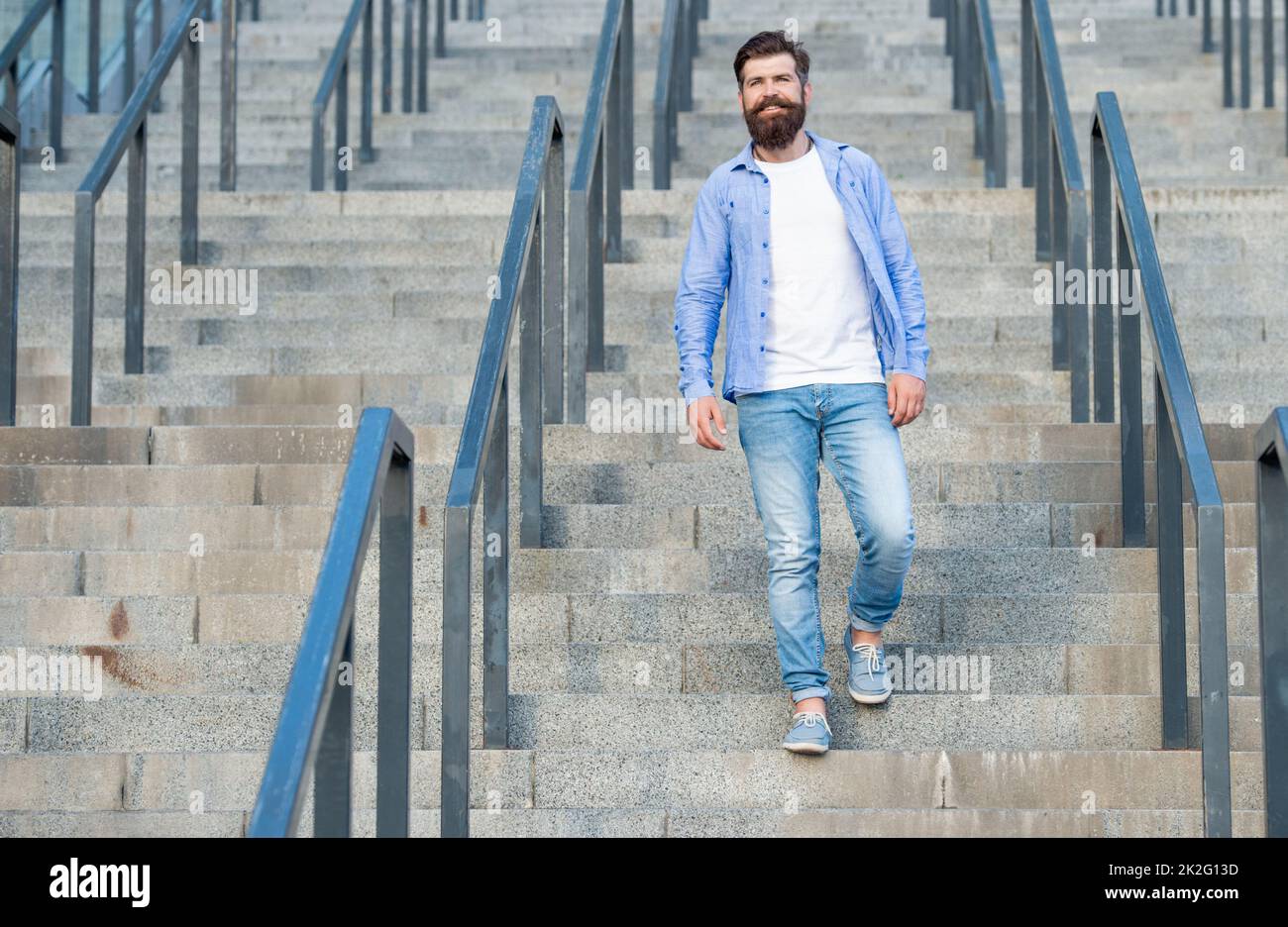 bearded man walk downstairs. full length of man with beard. hipster man ...