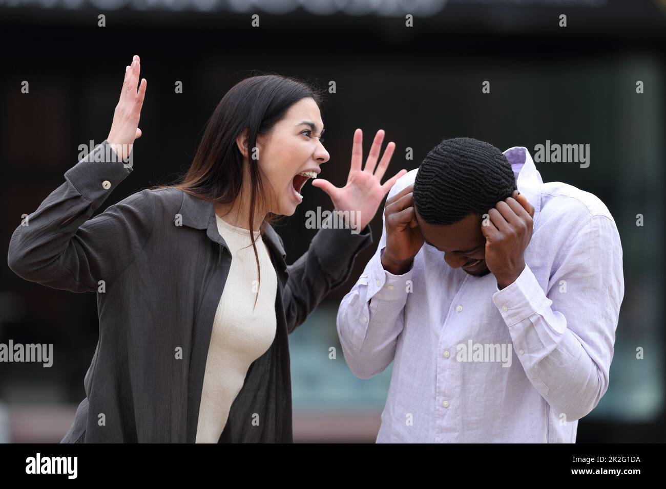 Angry woman scolding to a scared man Stock Photo - Alamy