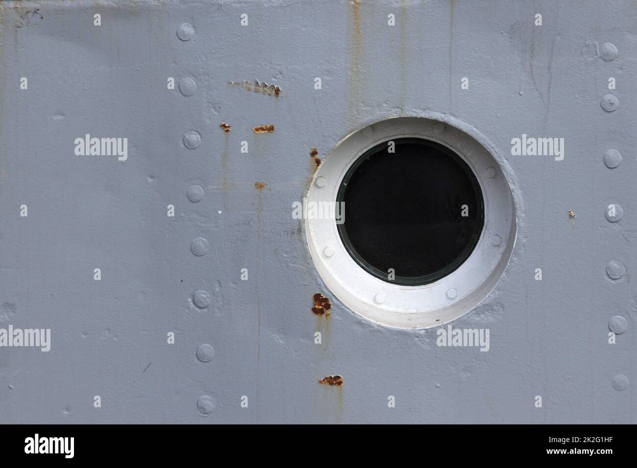 Porthole / round window in a steel wall Stock Photo - Alamy
