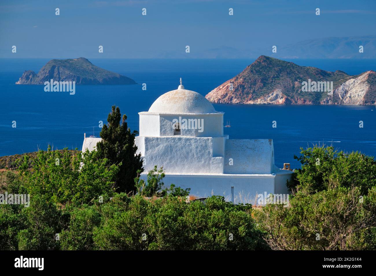 View of Milos island and Greek Orthodox traditional whitewashed church ...