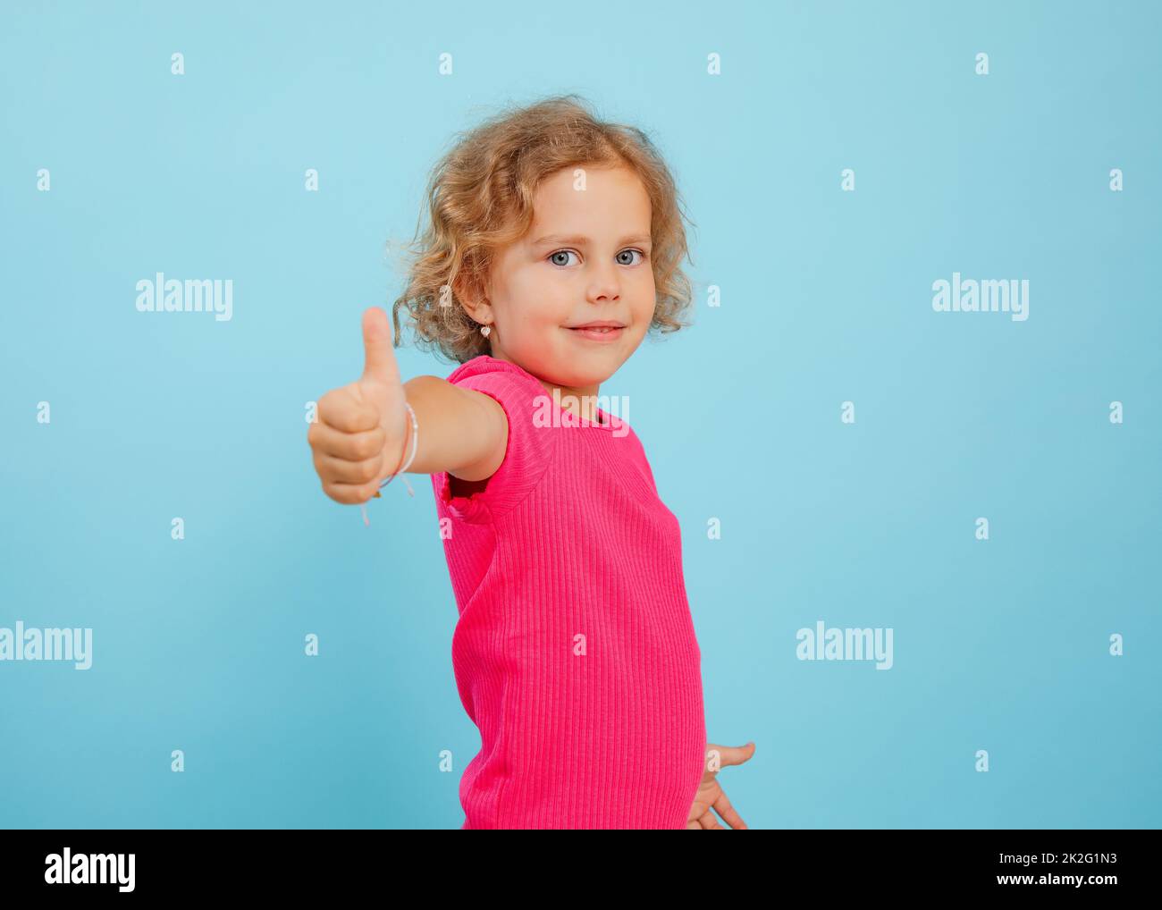 Charming little girl stand with finger up on outstretched arm on empty ...