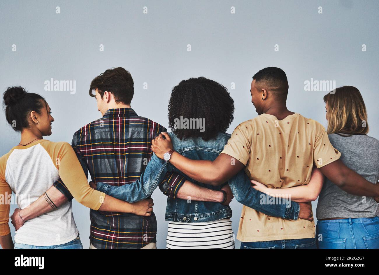 Our friends become our family. Rearview studio shot of a diverse group ...