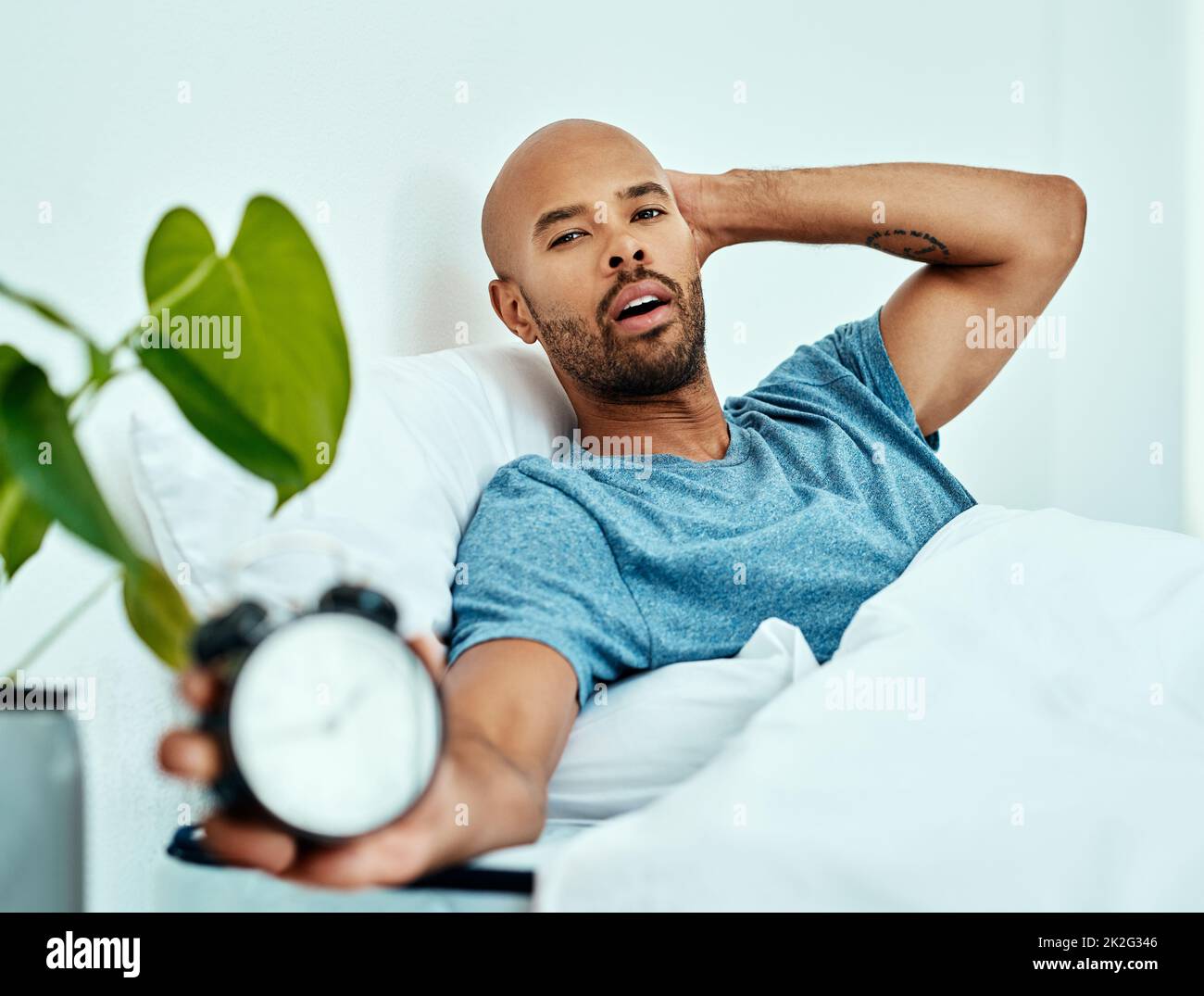 Man alarm clock bed hi-res stock photography and images - Alamy