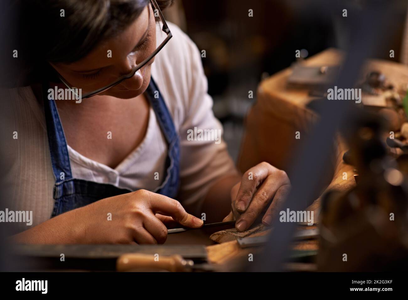 Crafted with care. An artist creating something out of wood Stock Photo ...