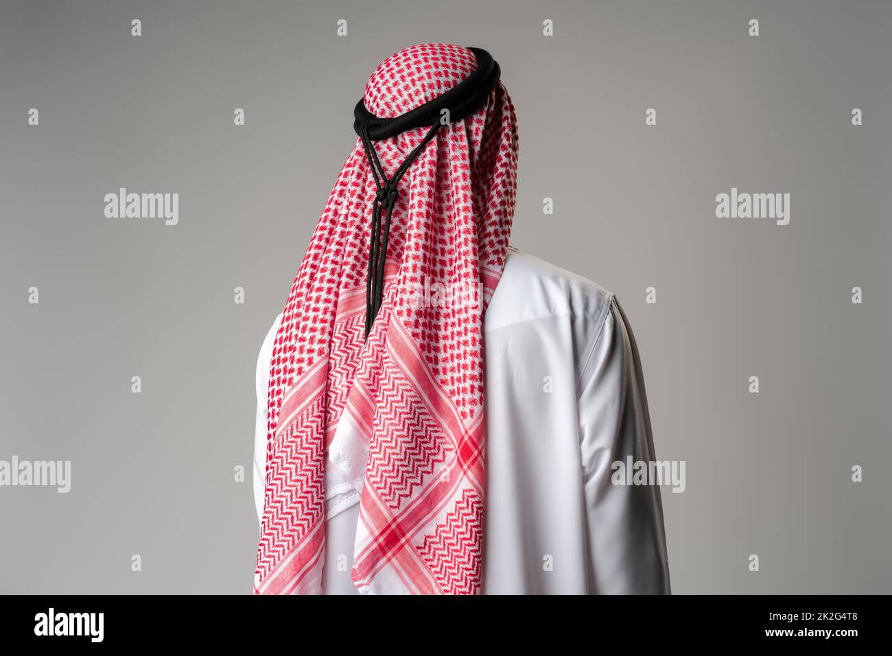 Back view of young Arab man standing on gray background Stock Photo - Alamy