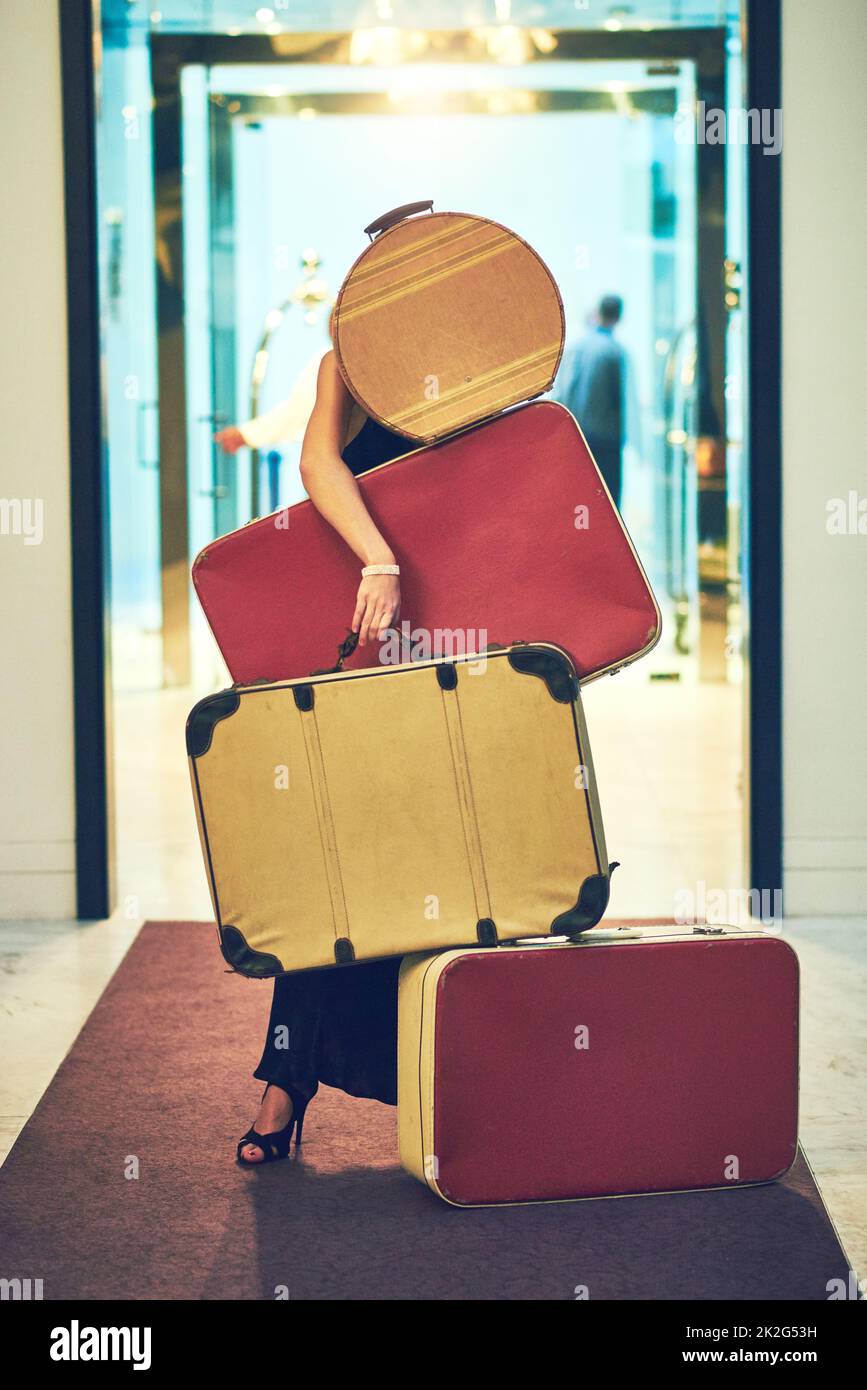 Woman carrying luggage hi-res stock photography and images - Alamy