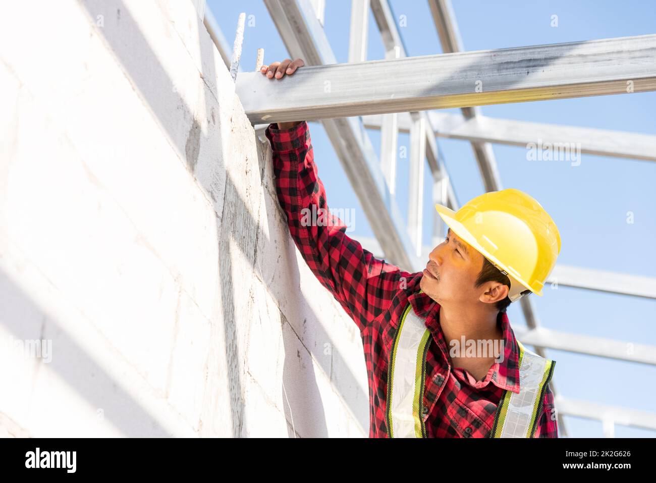 Construction worker or contractor checking house frame Stock Photo - Alamy