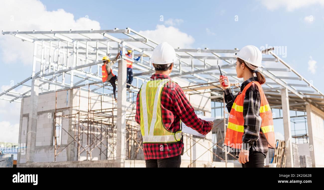 Back two architect and client discussing help create plan with ...