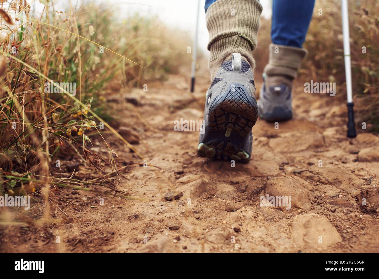 Sure-footed fitness. Cropped rear view of a hiker walking along a trail ...