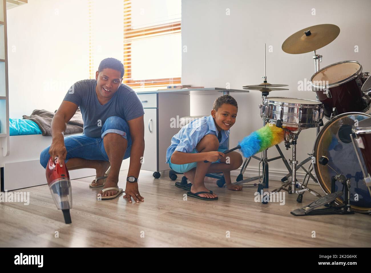 Keeping things clean. Portrait of a father and son cleaning around the ...