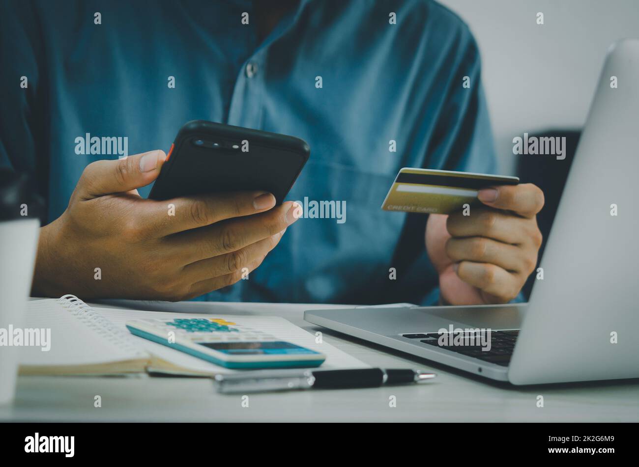 man hand holding credit card and mobile phone online shopping e ...