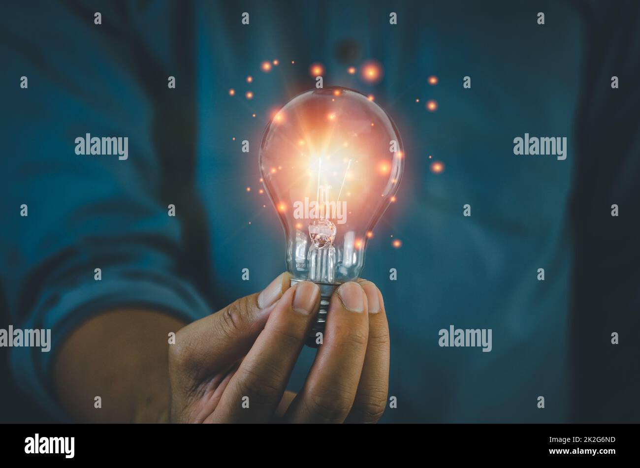 hand hold light bulb on black background.Inspiration and Creativity ...