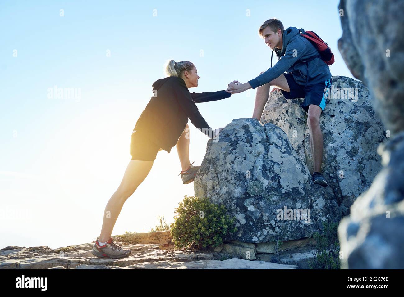 Helping hand couple hiker hi-res stock photography and images - Alamy