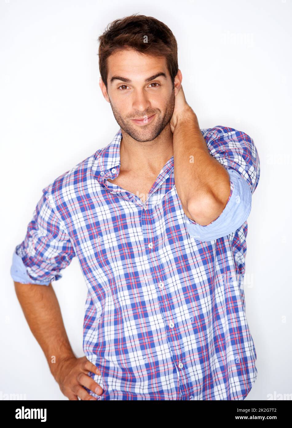 Casual modern charm. Handsome young guy in a check shirt with his hand ...