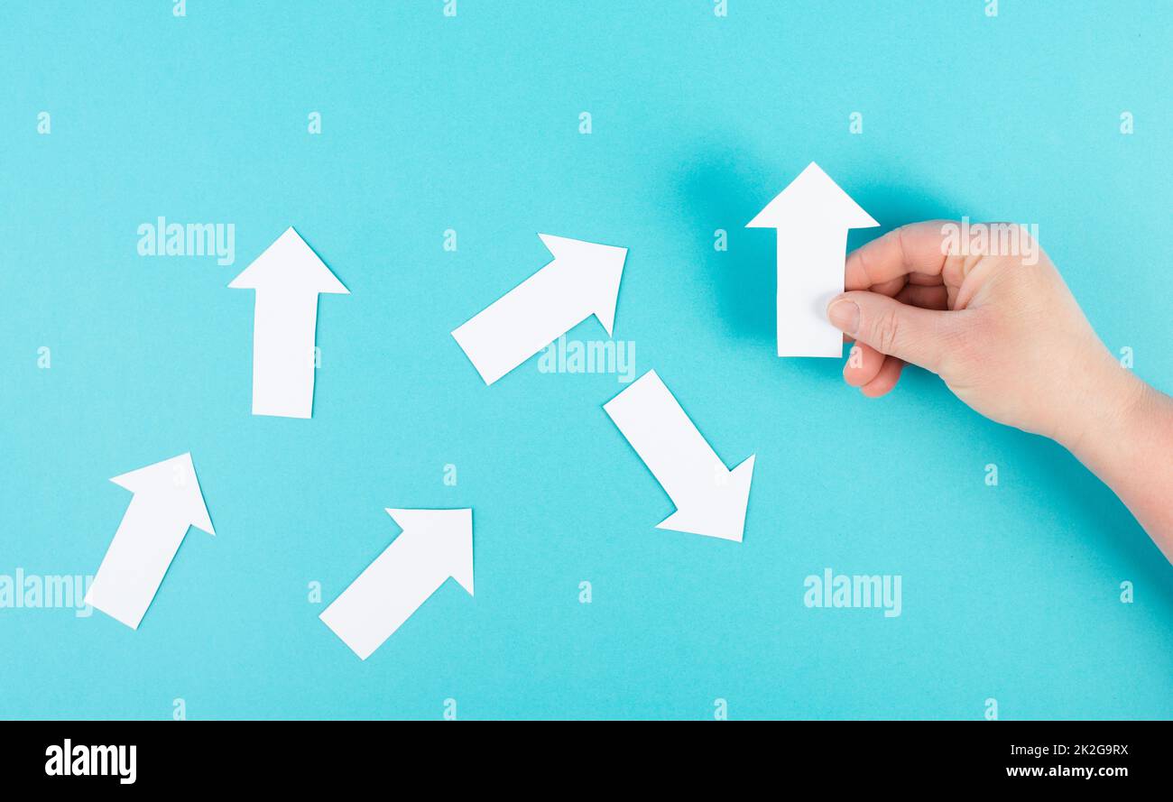 White arrows on a colored background, one red is standing out, do ...