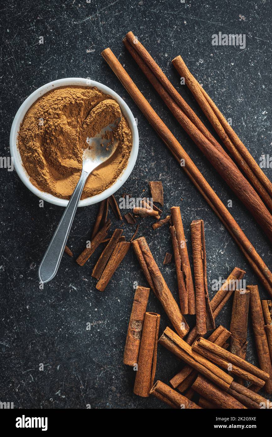 Dry cinnamon sticks and cinnamon powder on kitchen table. Cinnamon ...