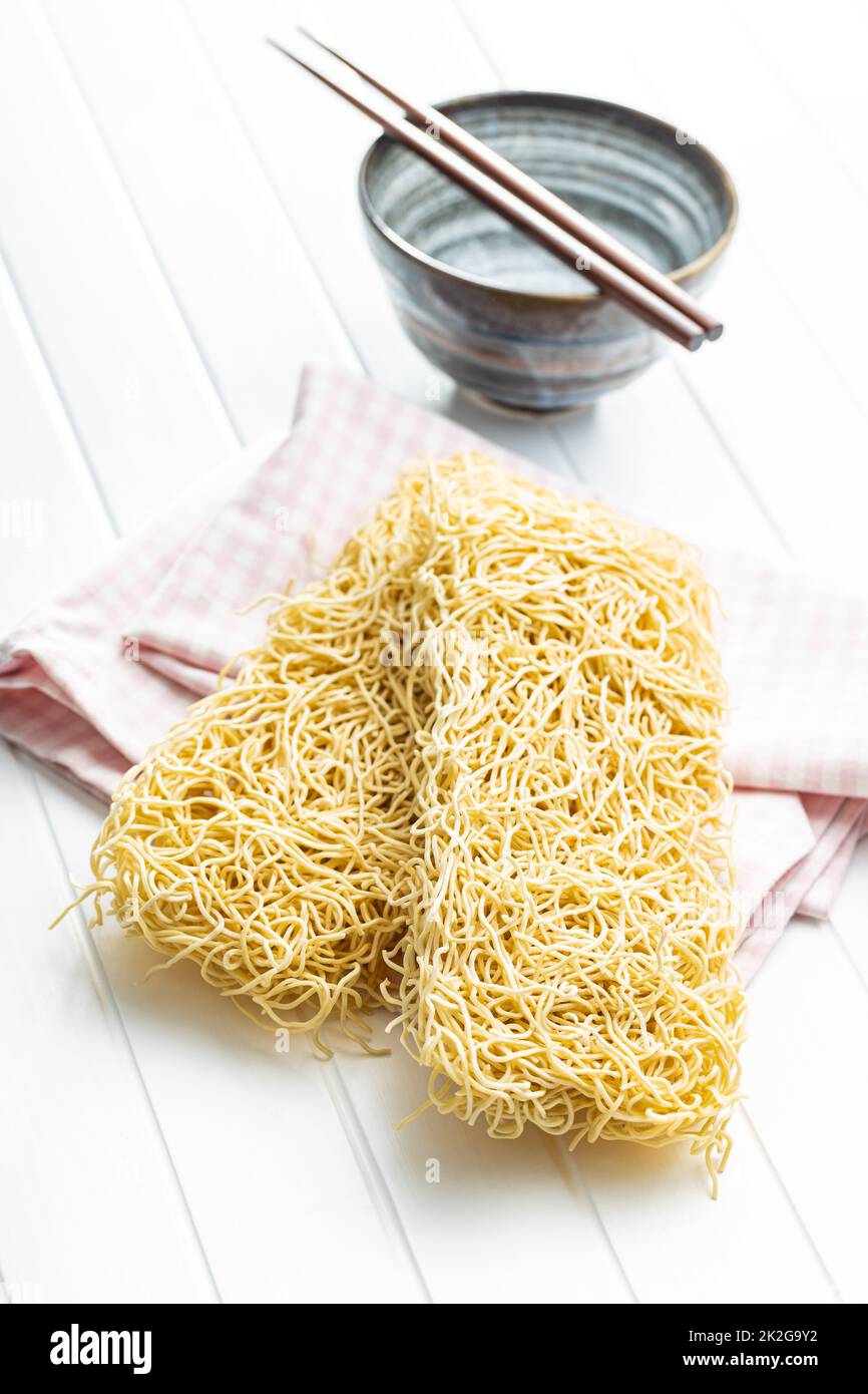 Instant noodles. Uncooked chinese noodles on white table Stock Photo ...