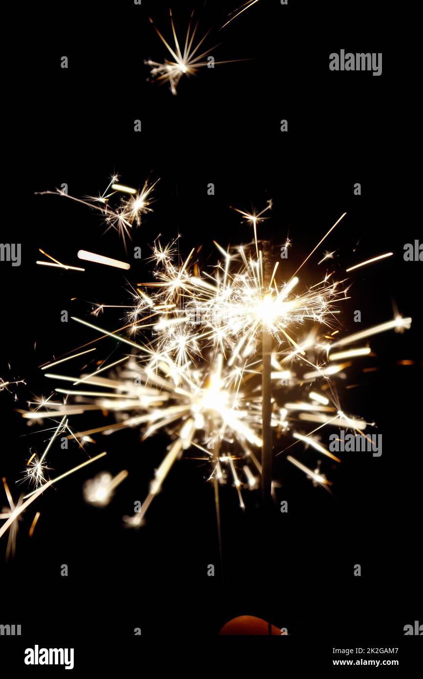 A sparkling sparkler at a party or New Year's Eve Stock Photo - Alamy