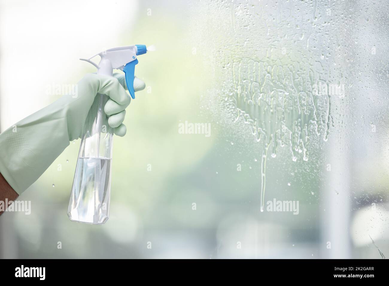 Cant have dirty windows in this house. Shot of an unrecognizable person ...