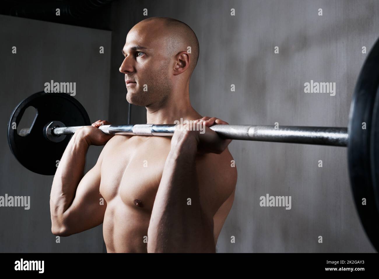 Lifting like a boss. a man working out with weights at the gym Stock ...