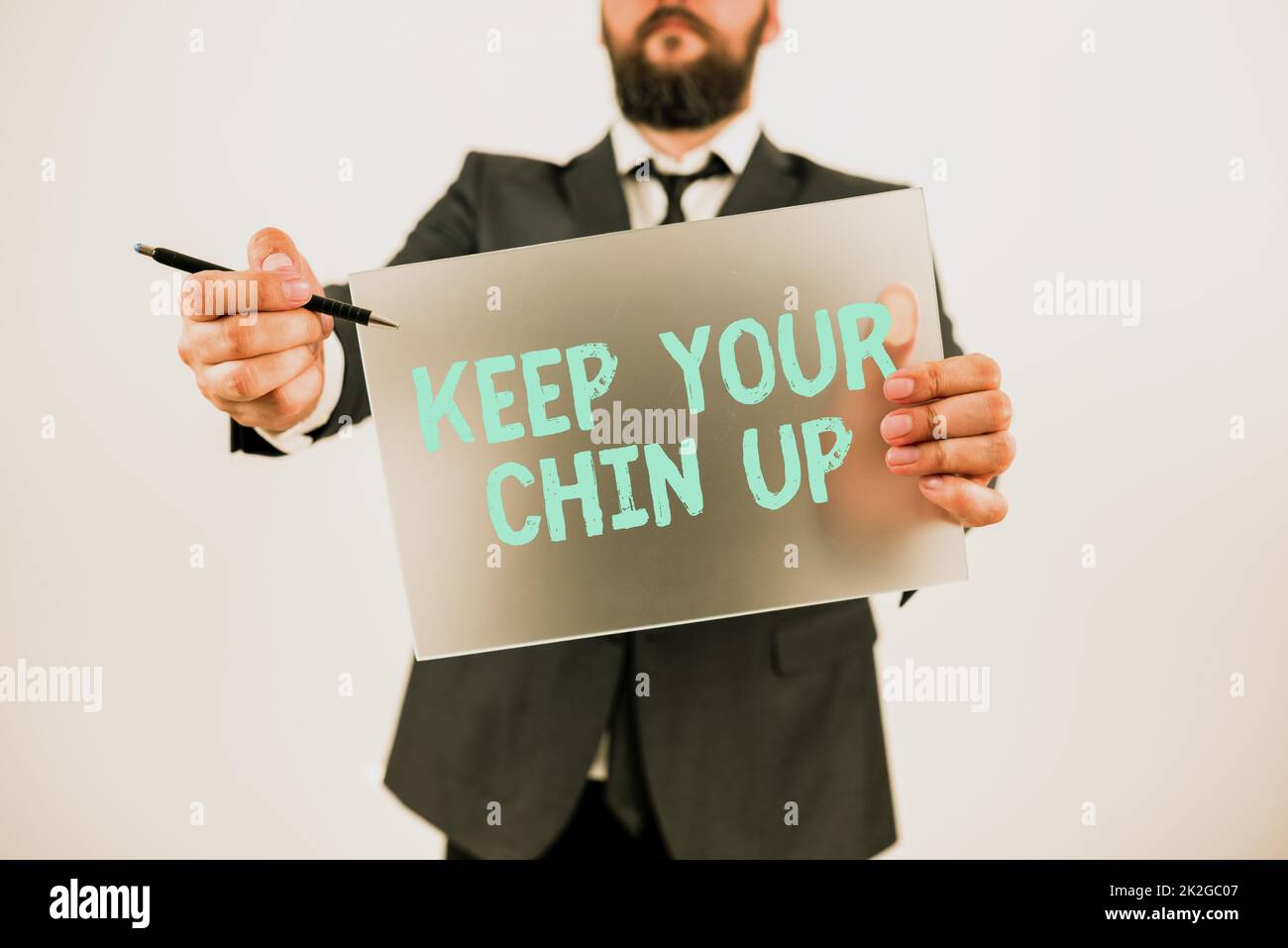 Hand writing sign Keep Your Chin UpRemain cheerful in difficult ...