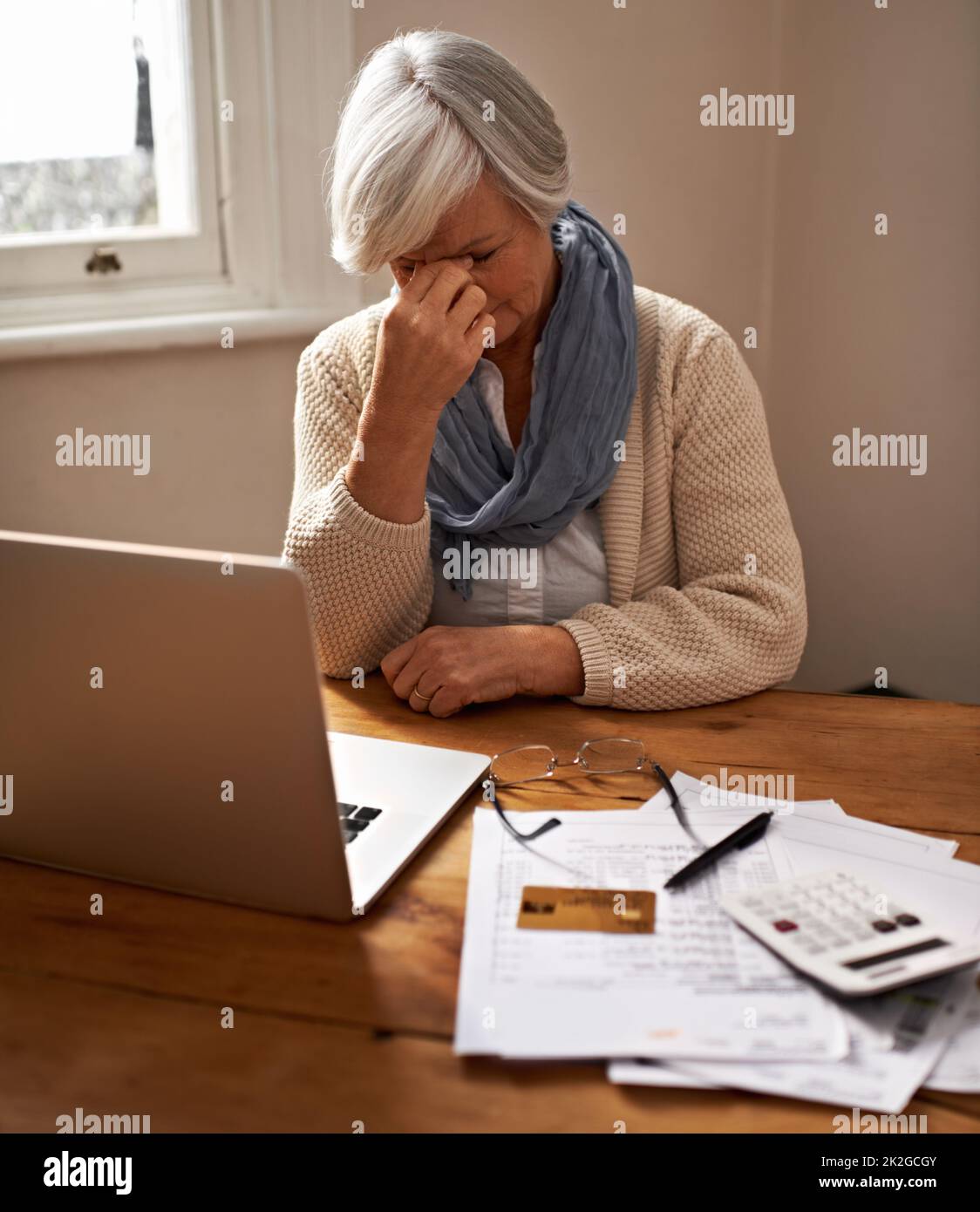 Retirement fund worries...An elederly woman sitting in front of her ...