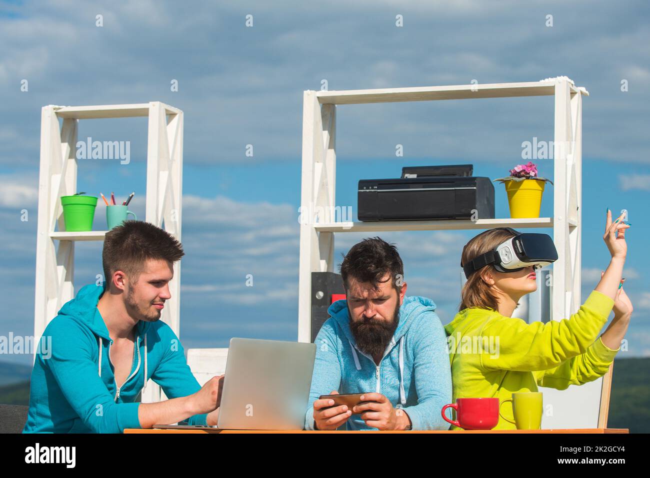 Team of three professional male and female designers wearing vr ...