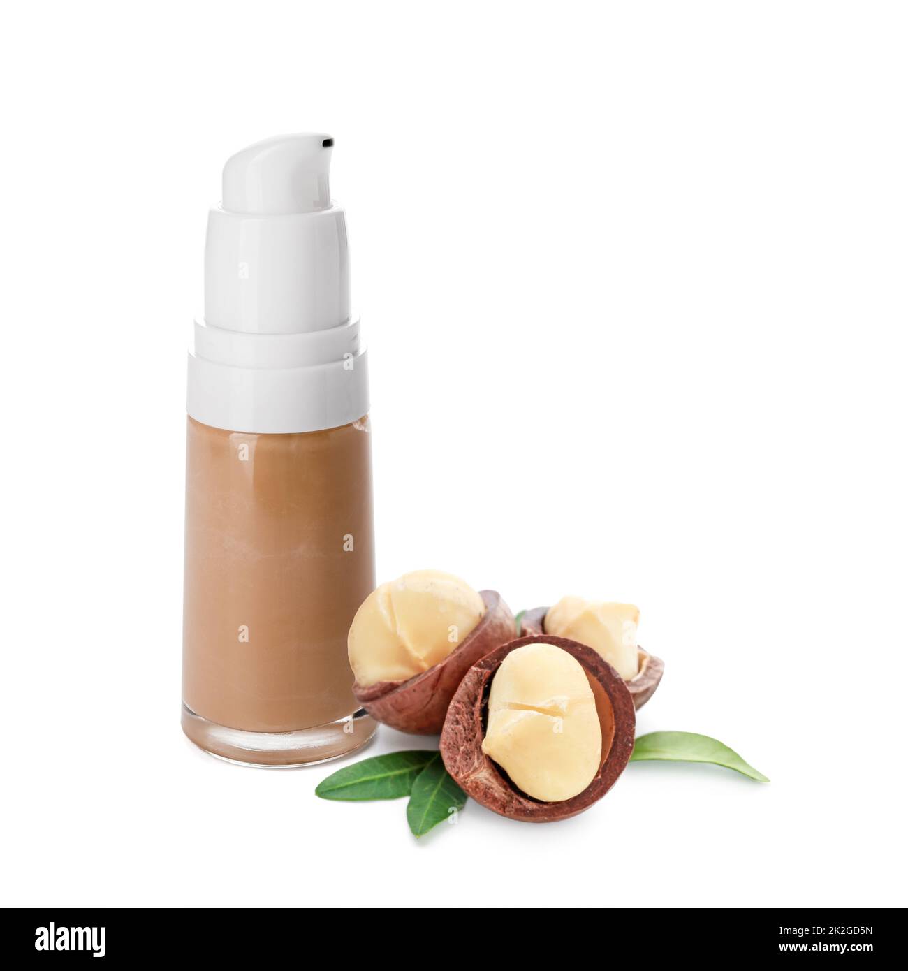 Bottle of natural cosmetics with macadamia nuts on white background ...
