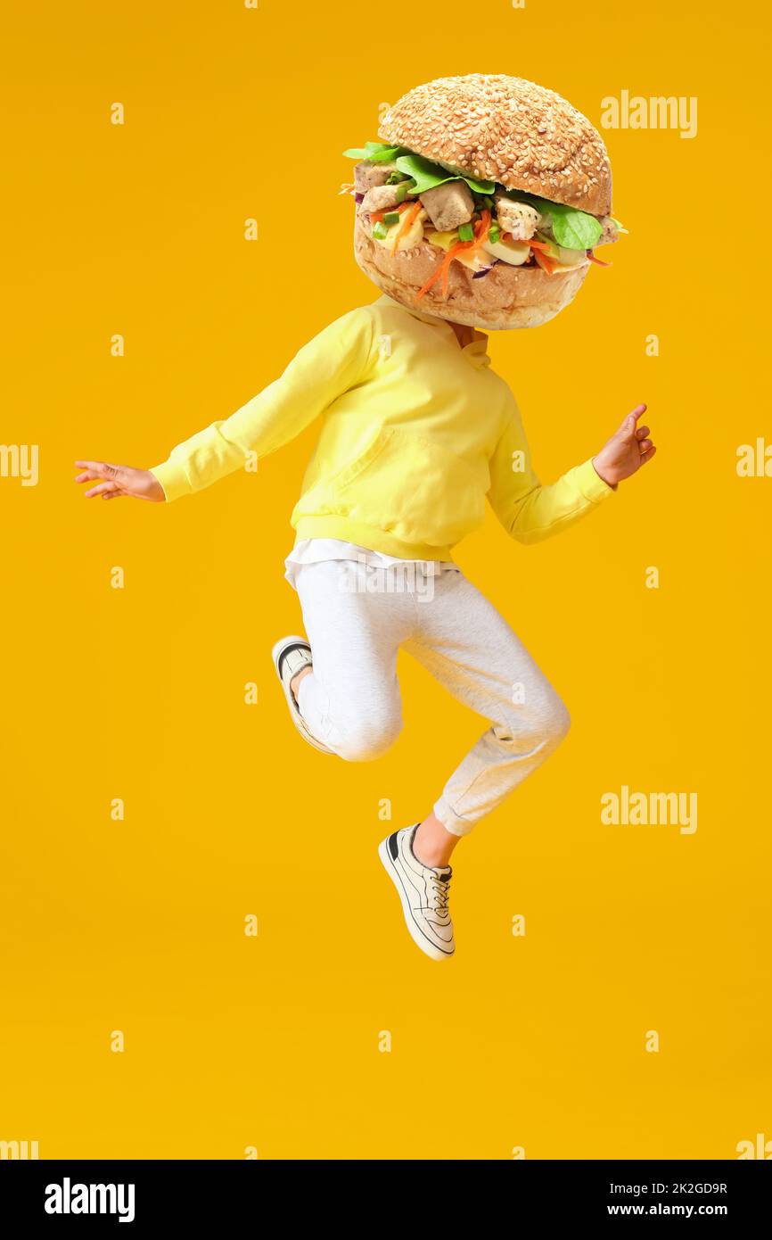 Jumping boy with tasty doner kebab in bun instead of his head on yellow ...