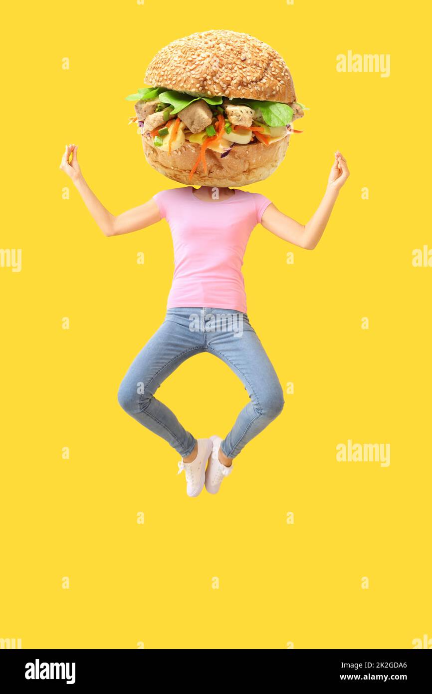 Jumping meditating woman with tasty doner kebab in bun instead of her ...