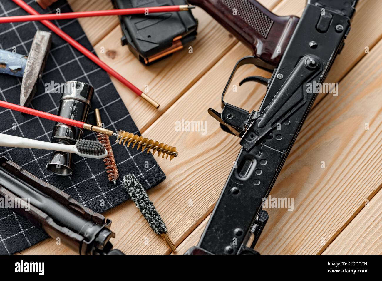 Black disassembled shotgun and cleaning tools on wooden table Stock ...