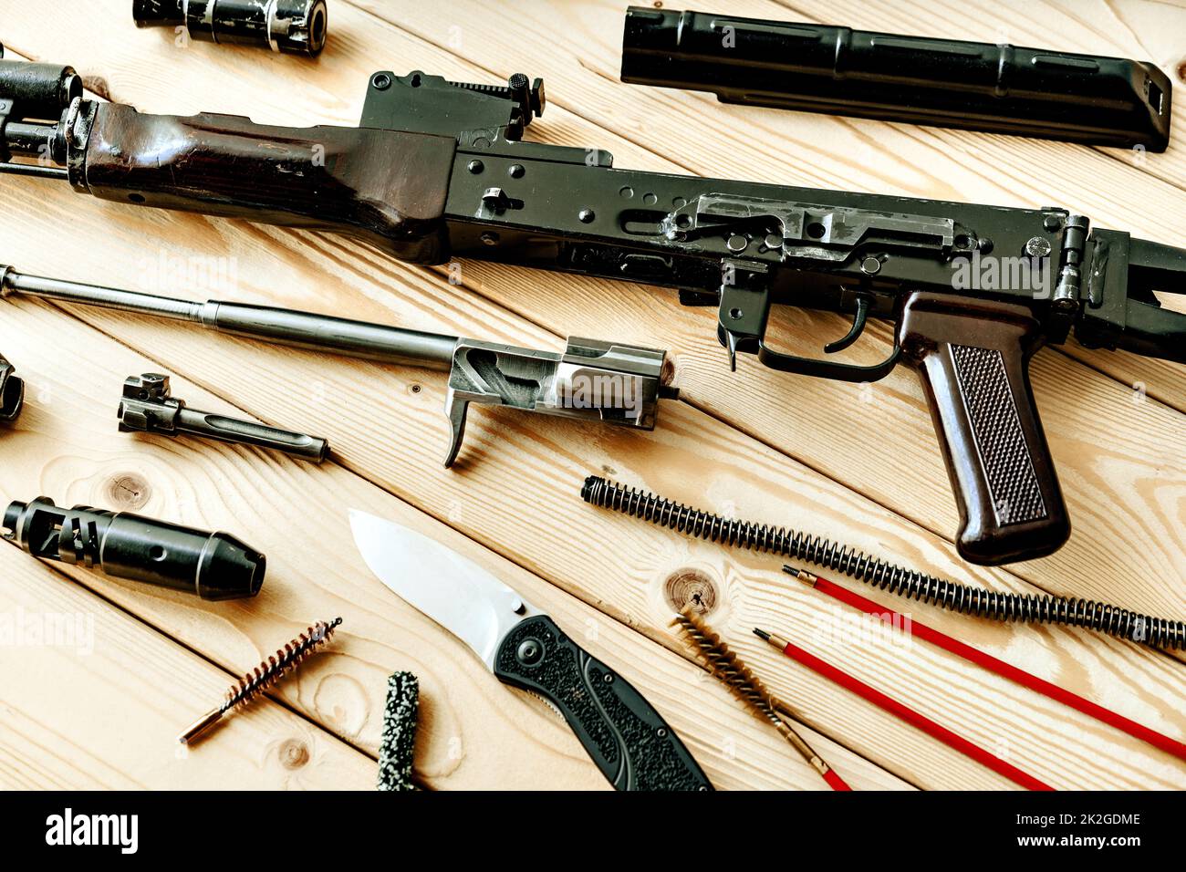 Disassembled rifle with cleaning tools on table of weapons workshop ...