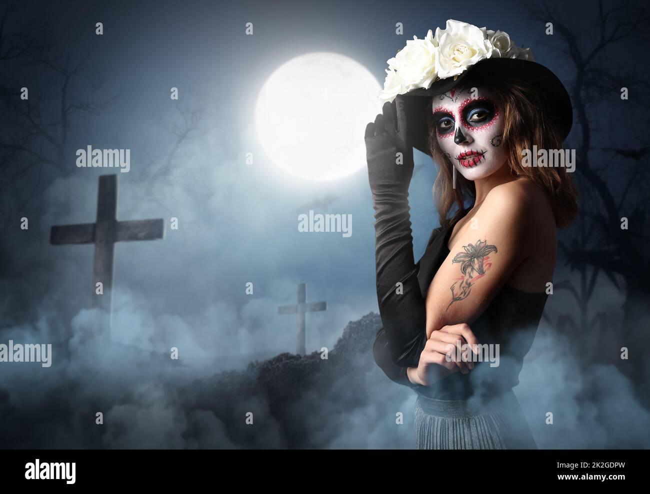 Young woman with painted skull on her face at night. Celebration of ...