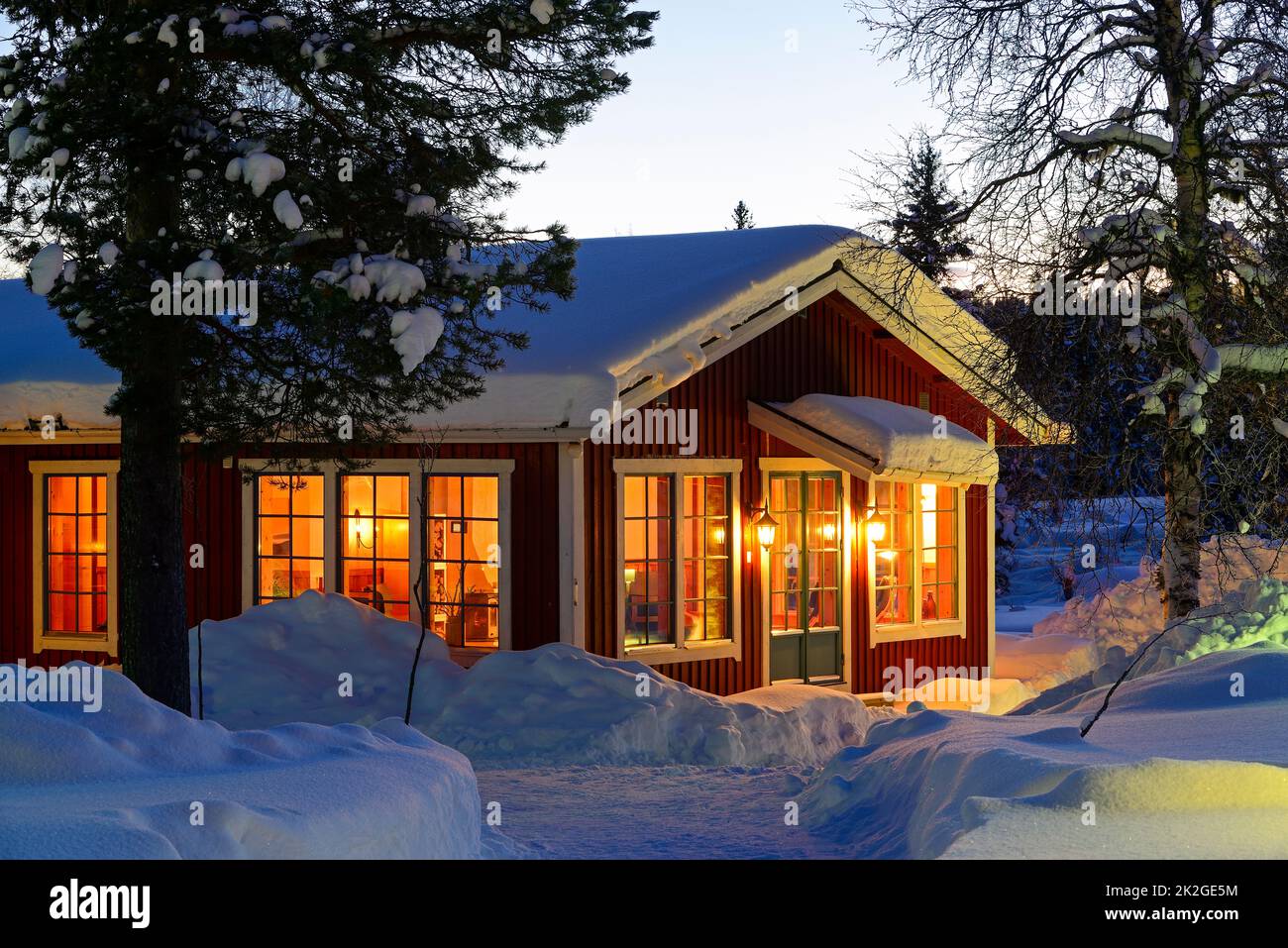 House with lights in windows and snowy winter outside Stock Photo - Alamy
