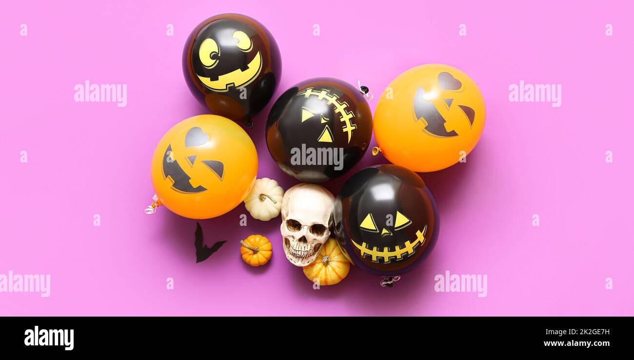 Halloween balloons, skull and pumpkins on violet background Stock Photo ...