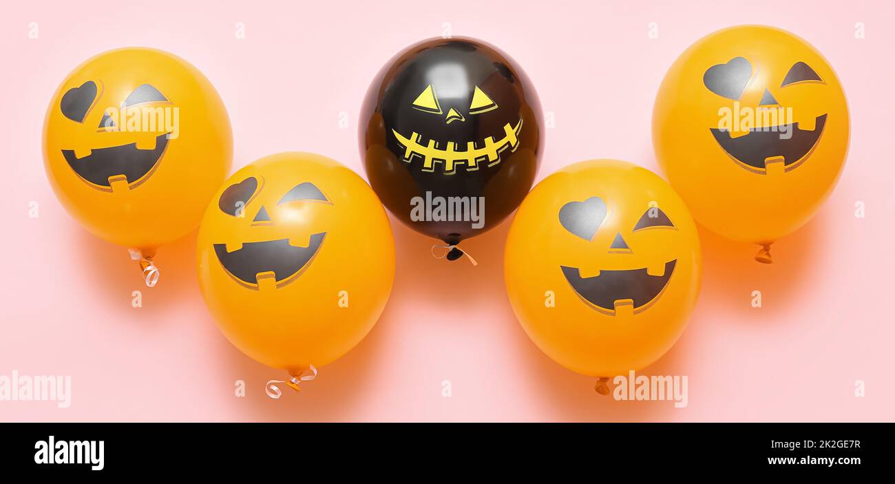 Funny Halloween balloons on pink background, top view Stock Photo - Alamy