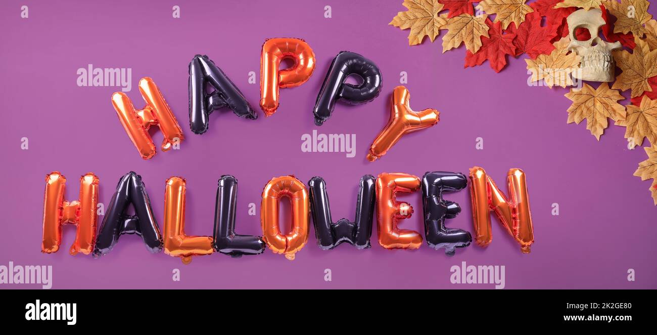 Text HAPPY HALLOWEEN made of balloons, autumn leaves and skull on ...