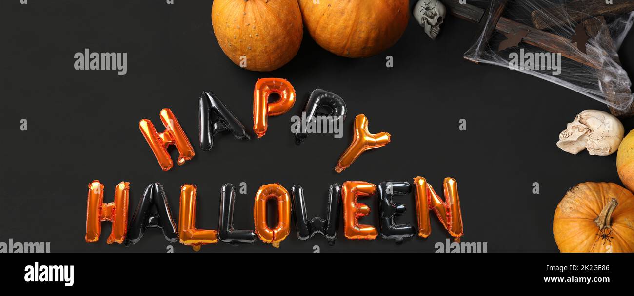 Text HAPPY HALLOWEEN made of balloons, pumpkins, skulls and spiderweb ...