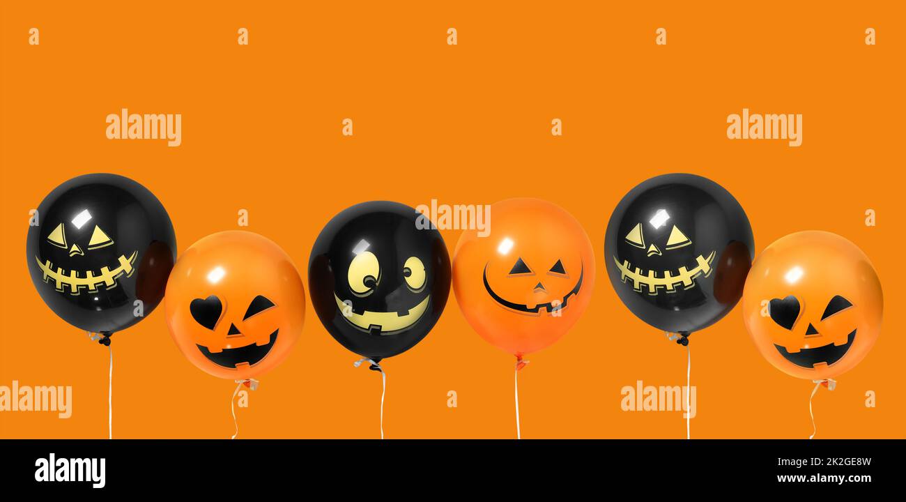 Funny Balloons for Halloween party on orange background Stock Photo - Alamy