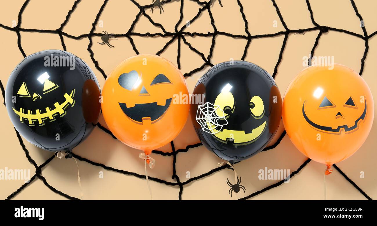Halloween balloons and spider web on beige background Stock Photo - Alamy