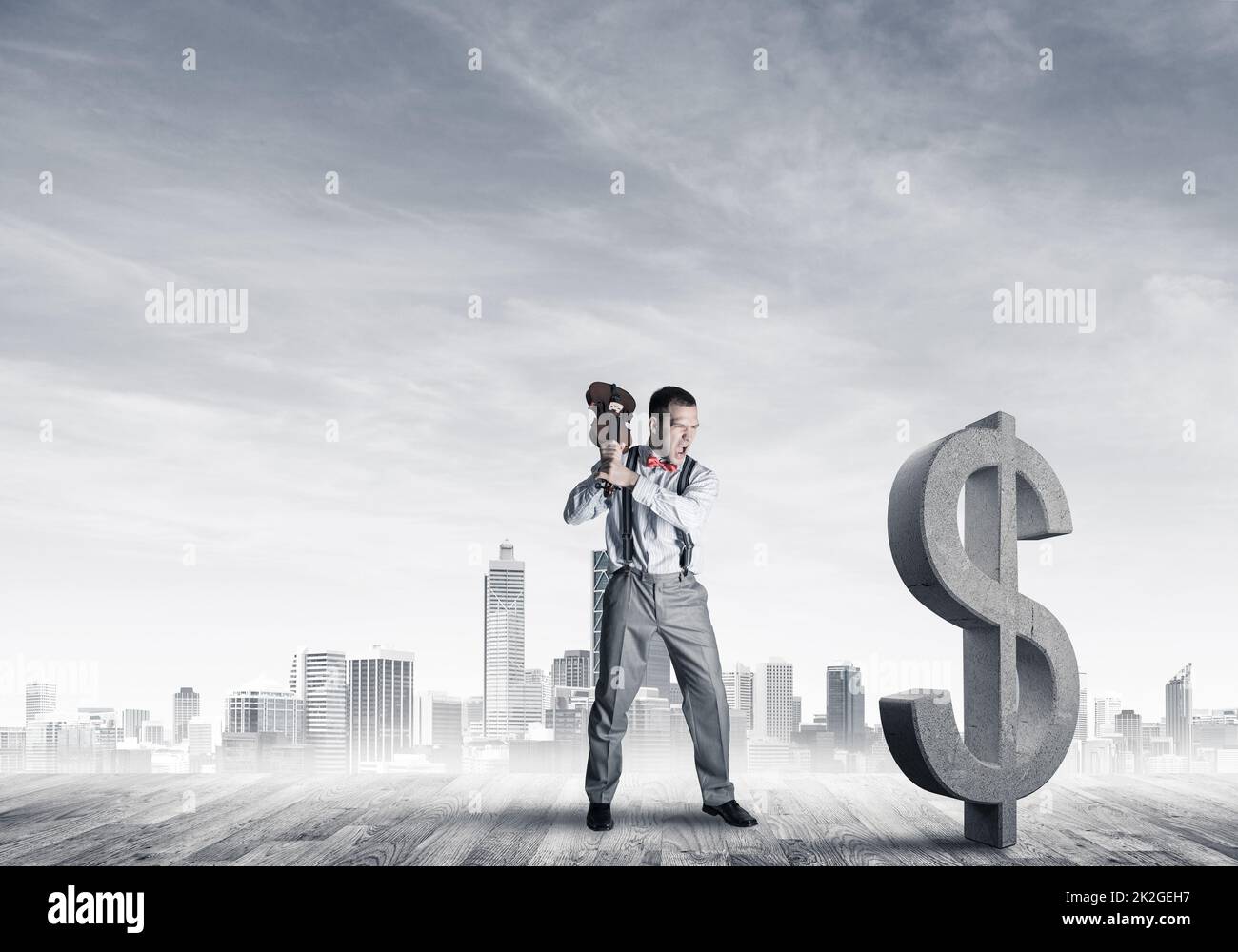Determined banker man against modern cityscape breaking dollar concrete ...