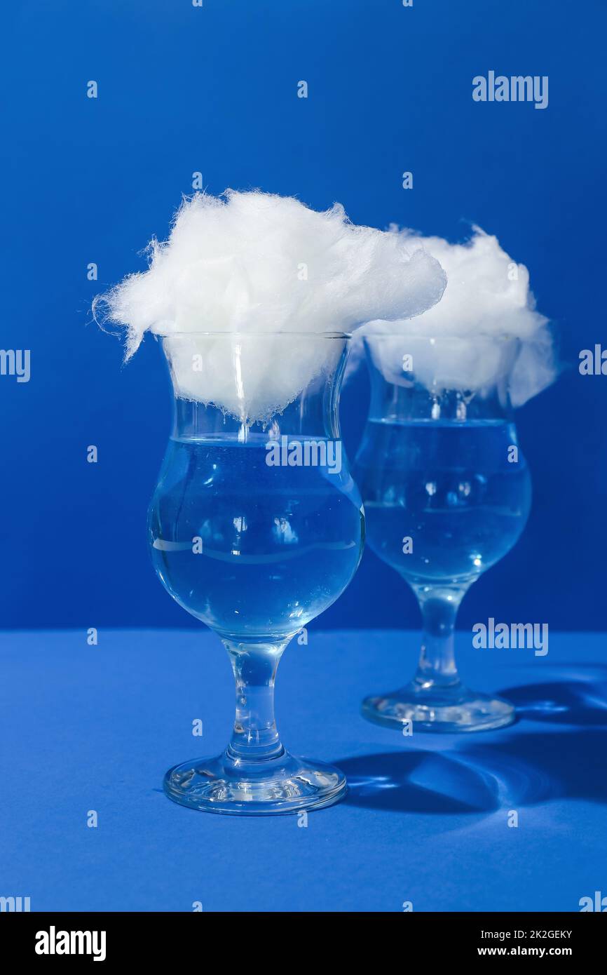 Glasses with tasty cotton candy cocktail on blue background Stock Photo ...