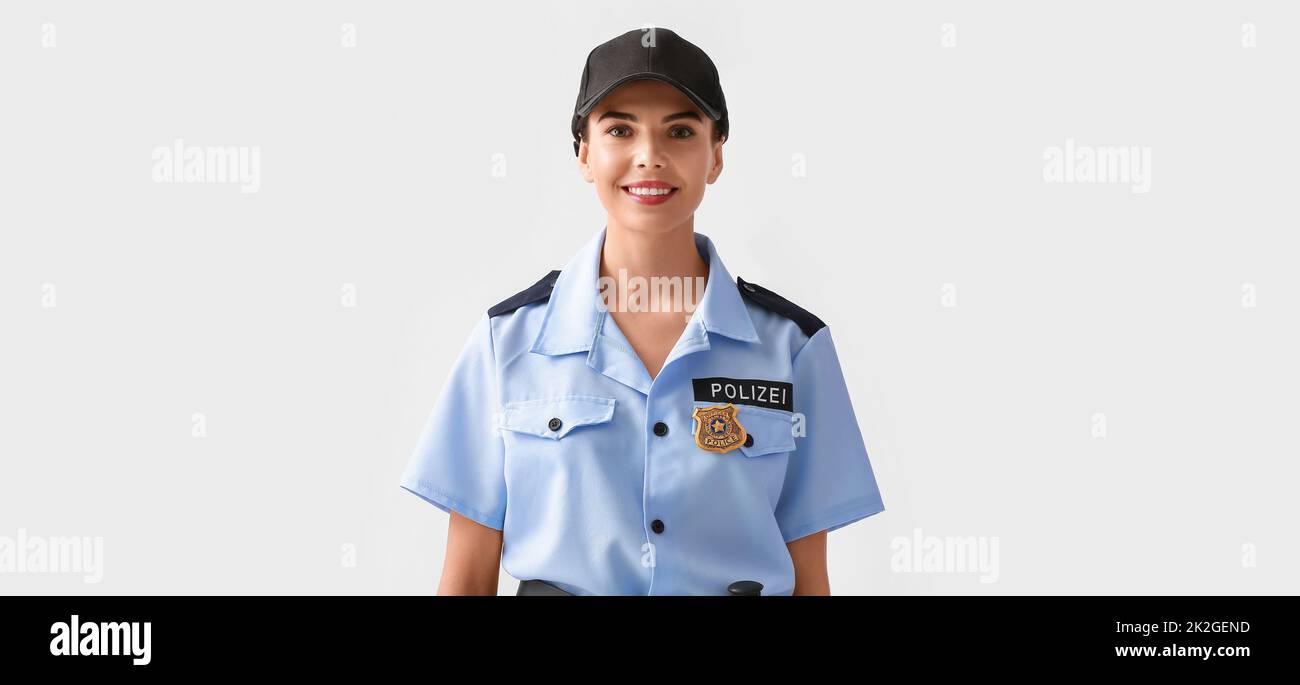 Female police officer on light background Stock Photo - Alamy